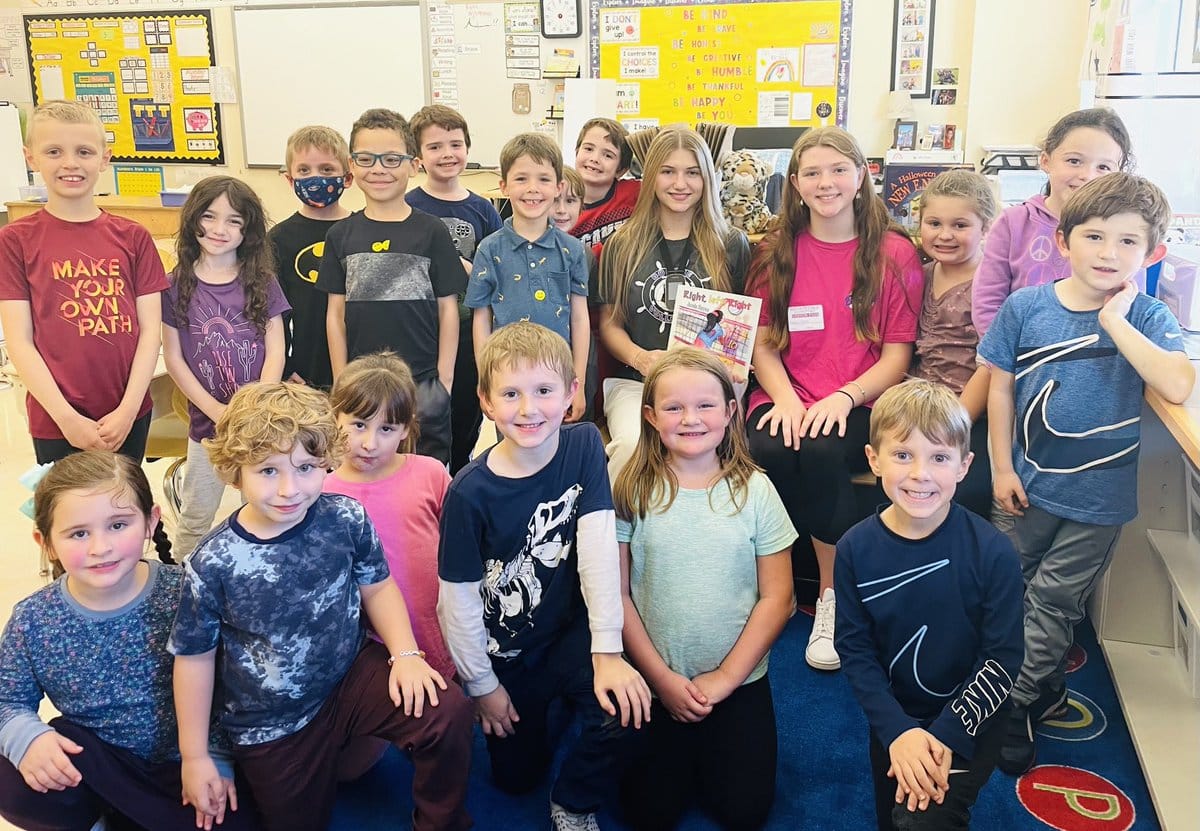 BHS Volleyball players reading to BES students | Team Up 4 Community