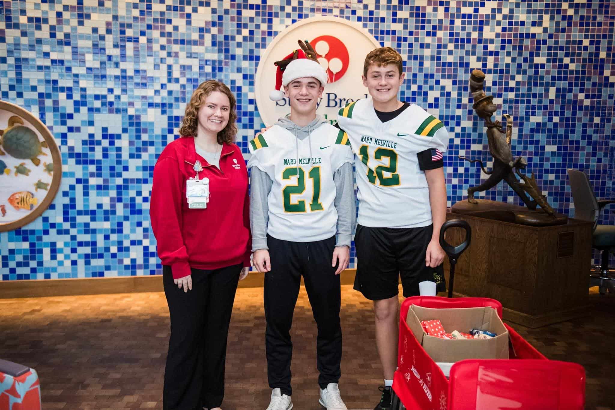 Festive off the field: football team makes donation to Stony Brook ...